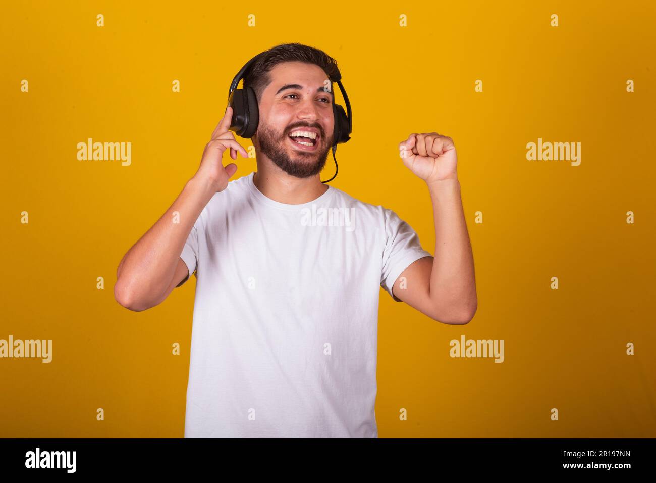 Brazilian latin american man, happy, with music headset, enjoying a ... Brazilian latin american man, happy, with music headset, enjoying a ...