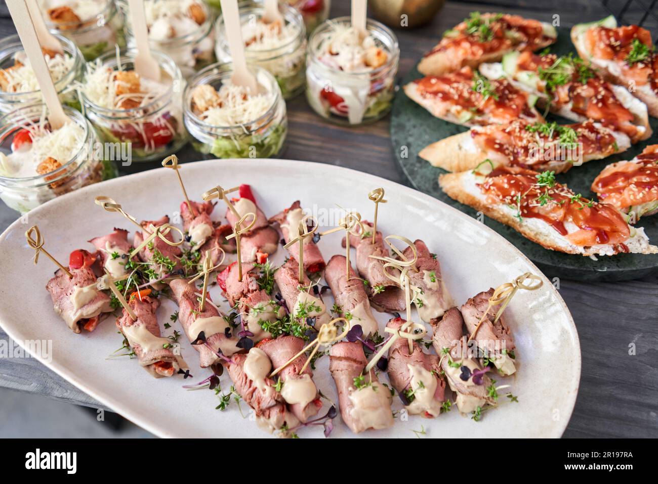 Delicious canapes with pork ham with dried tomatoes. Tasty buffet table ...