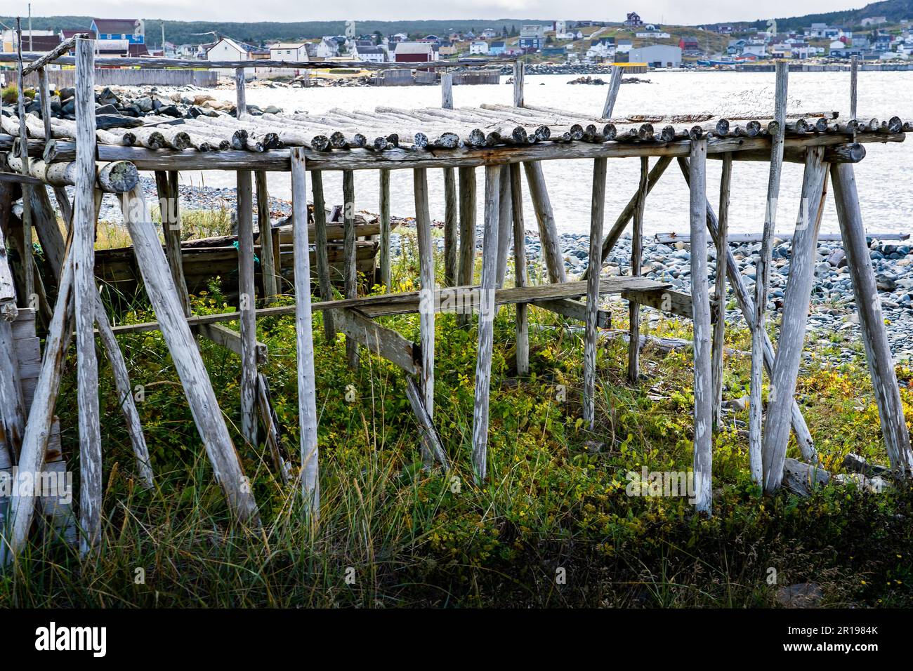 Wooden salt cod drying racks and distant historic buildings overlooking ...