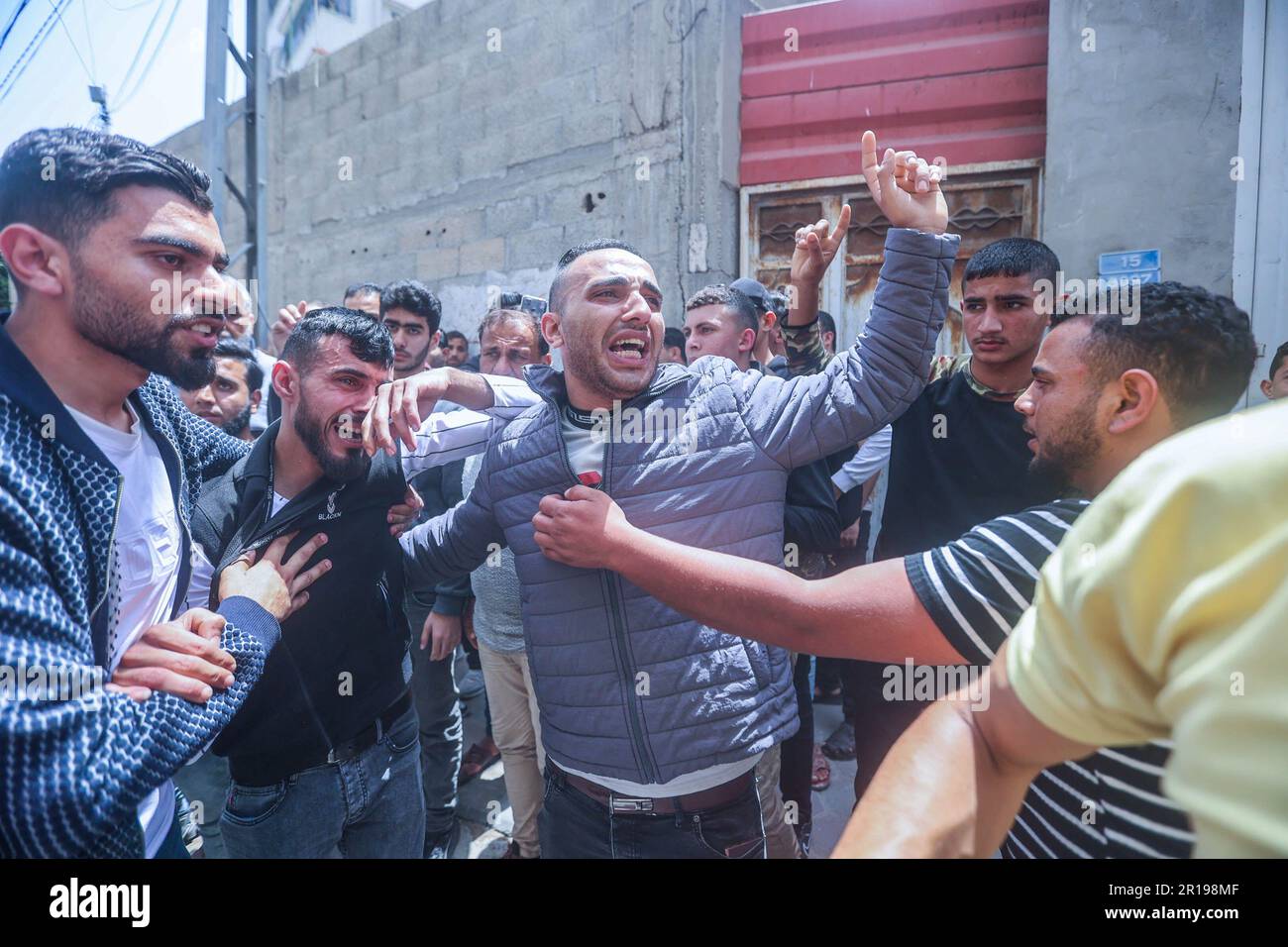 Gaza, Palestine. 12th May, 2023. Palestinians react as they attend the ...