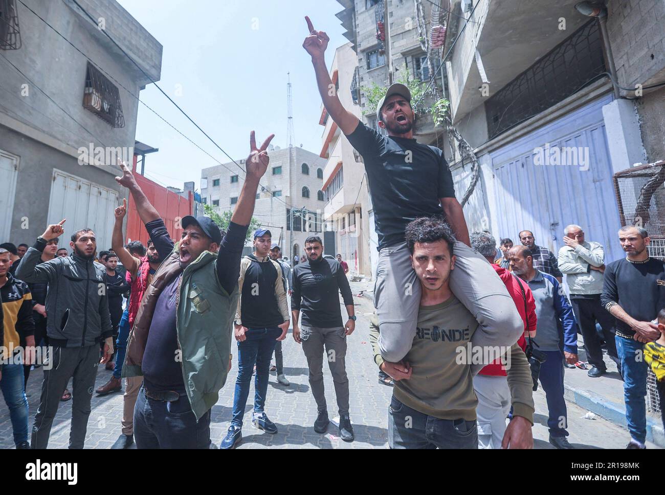 Gaza, Palestine. 12th May, 2023. Palestinian men react as they attend ...
