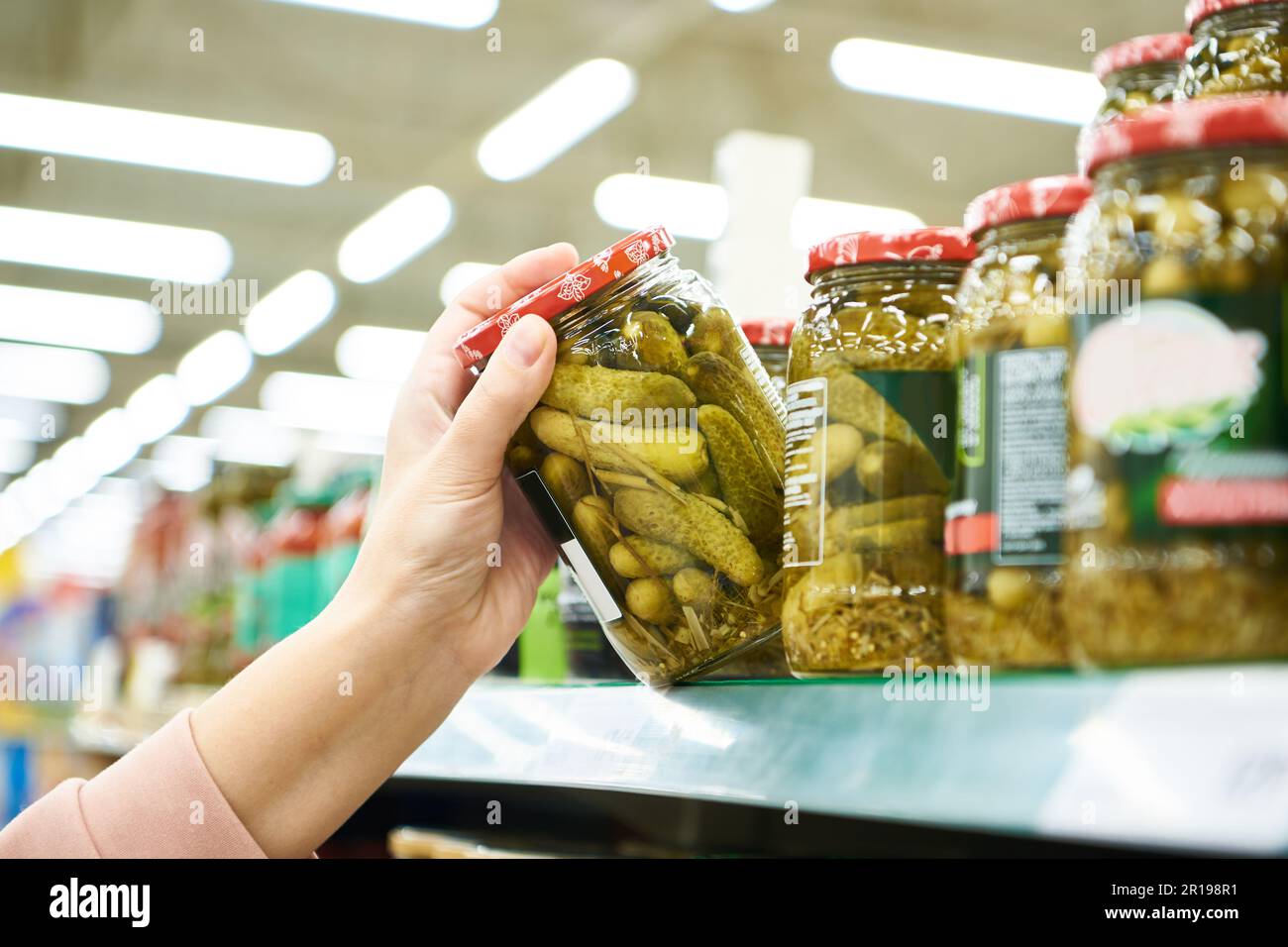 Pickled cucumbers in a jar in a store Stock Photo - Alamy