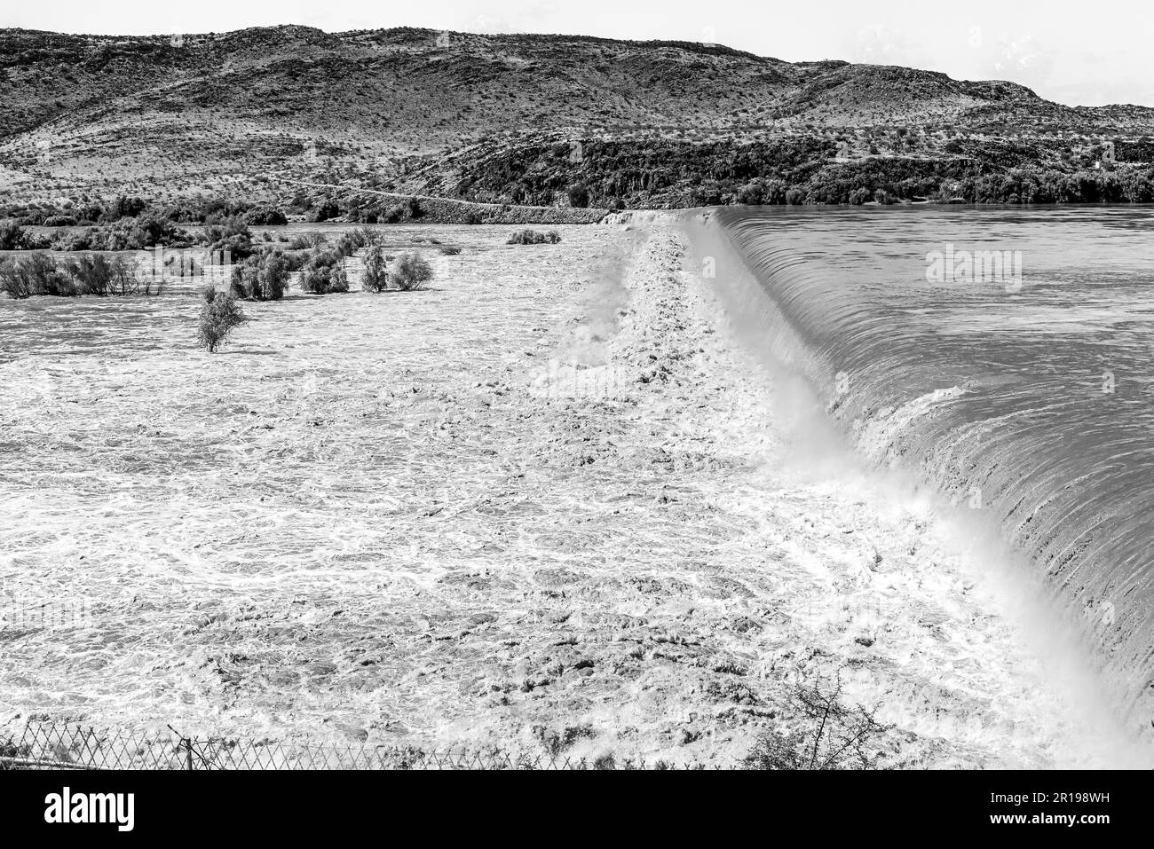 The wall of the Boegoeberg Dam is completely covered by the flooded ...