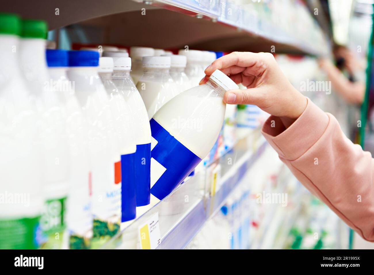Woman shopping milk in grocery store Stock Photo - Alamy
