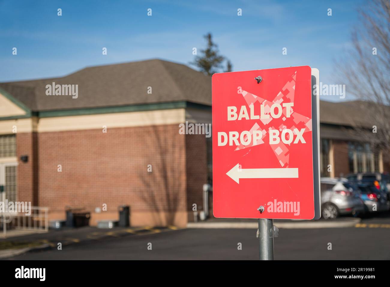 Bright red sign reading Ballot Drop Box at voting location. Selective ...