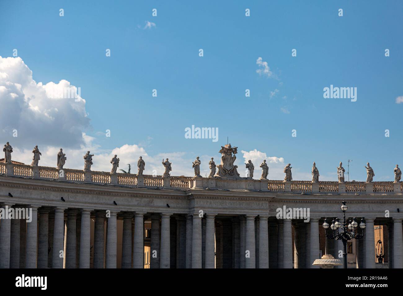 Statues of famous people above the building with columns in the Vatican ...