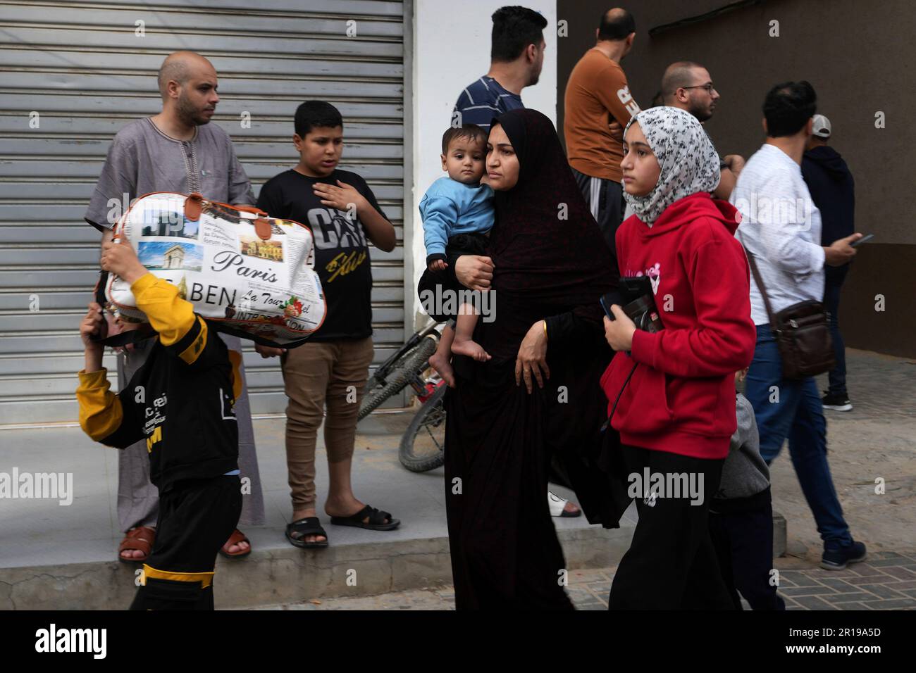 A Palestinian family flee from a building where an apartment was hit by ...