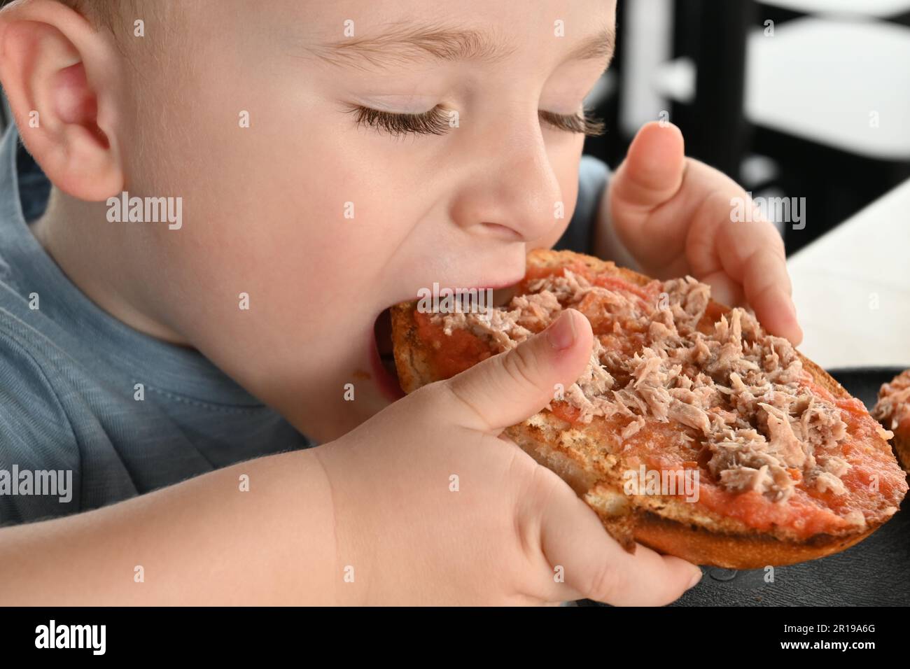Nothing better than a good breakfast. A cute little boy eating toast ...