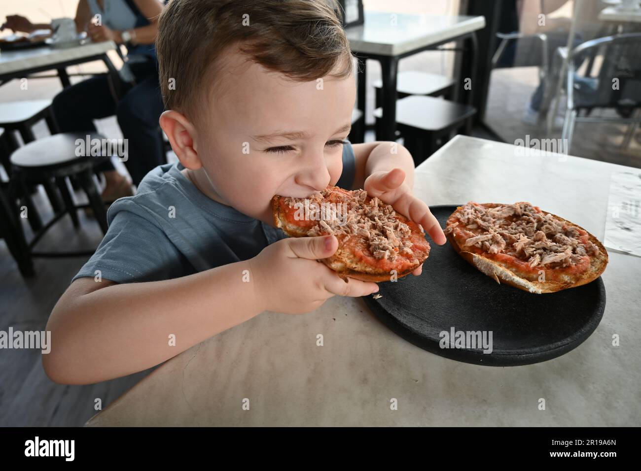 Nothing better than a good breakfast. A cute little boy eating toast ...