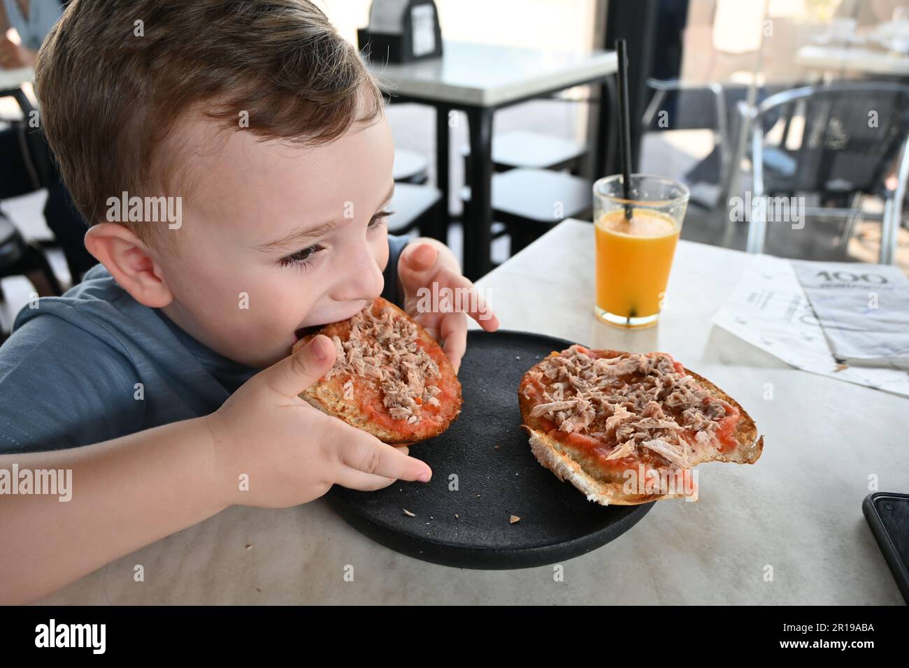 Nothing better than a good breakfast. A cute little boy eating toast ...