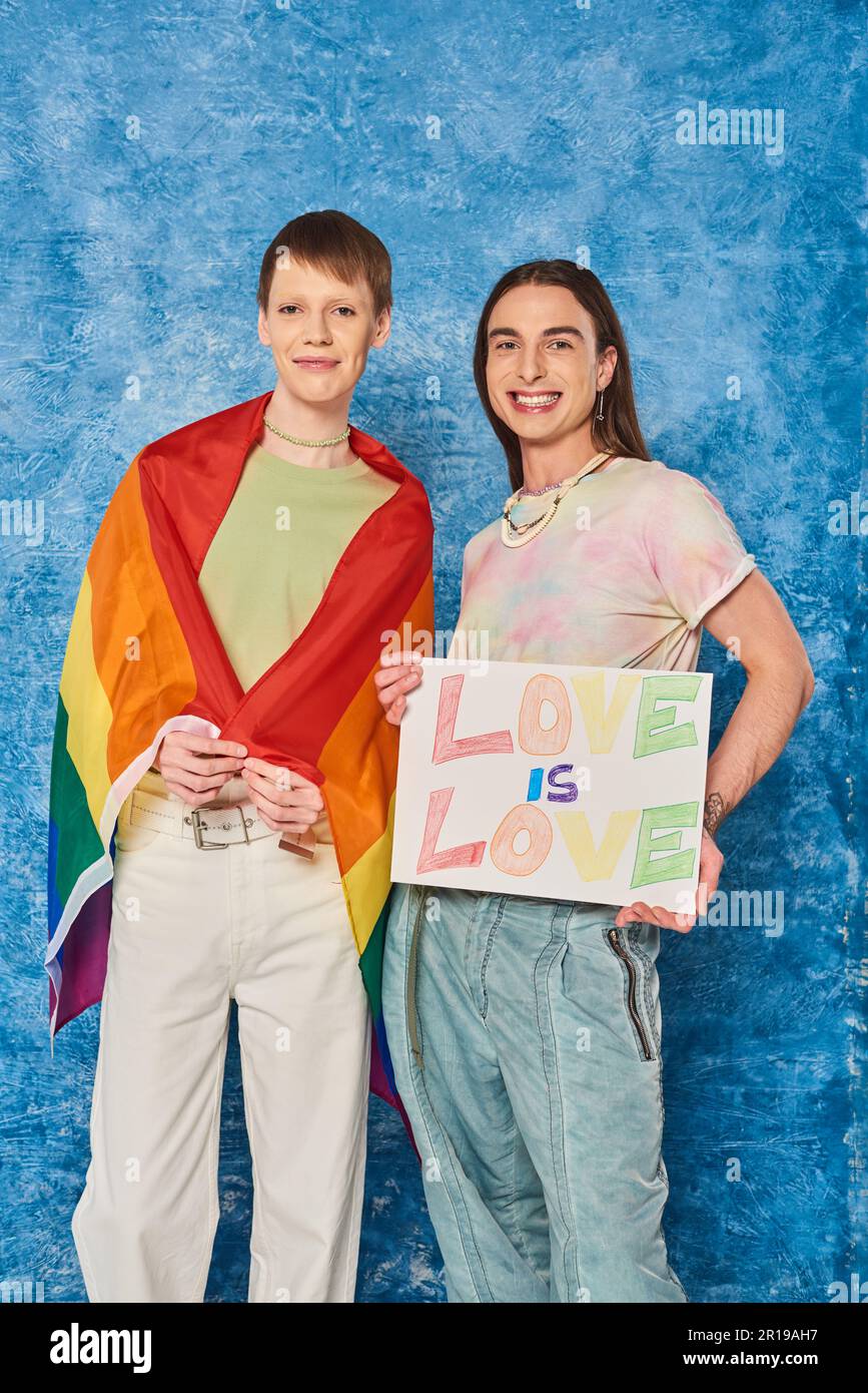 Carefree queer community with lgbt flag holding placard with love is ...