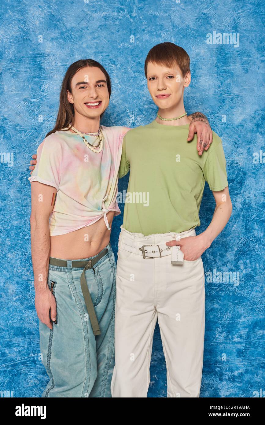 Young homosexual friends posing and hugging while looking at camera ...