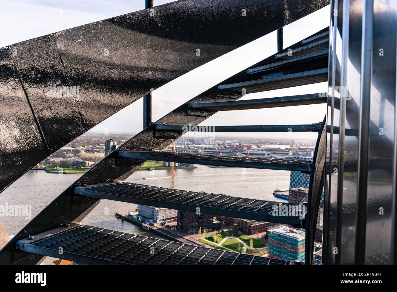 View over an open stair case high above the port of Rotterdam.spiral ...