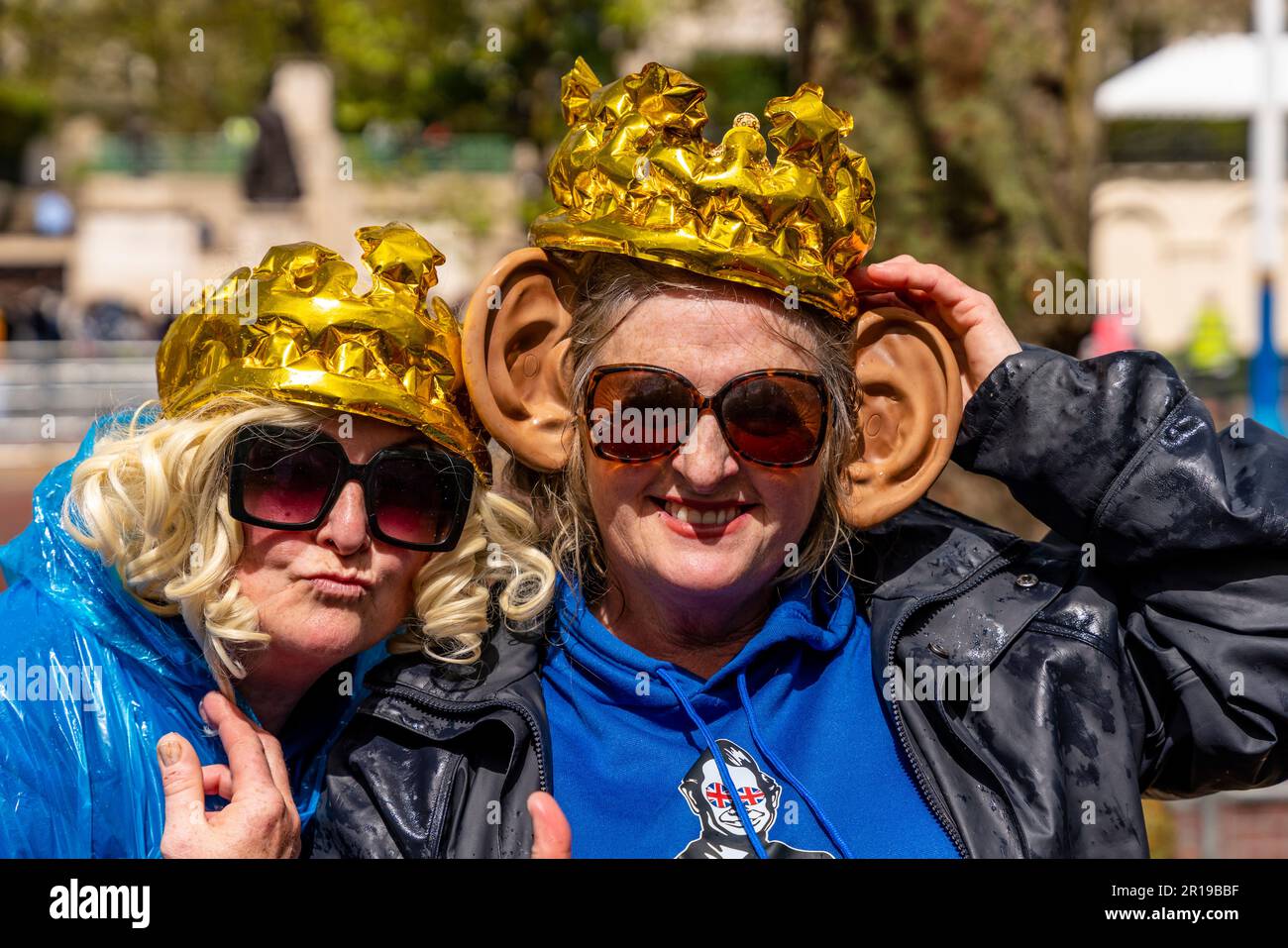 Two Women Wearing Fancy Dress Crowns Pose For A Photo Before The ...