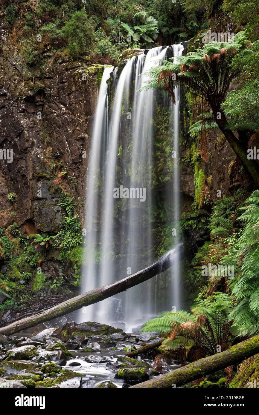 A picturesque landscape featuring a series of cascading waterfalls ...