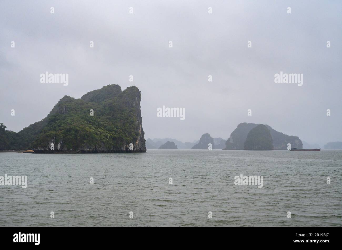 The typical limestone islands and islets in low clouds and mist in Bai ...