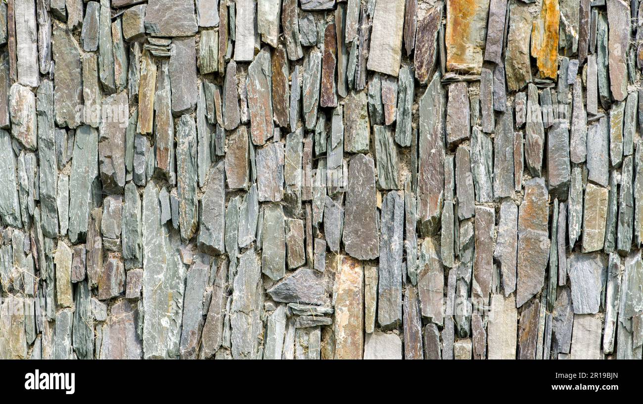 A fence made of stone plates as a background. Stone background. The ...