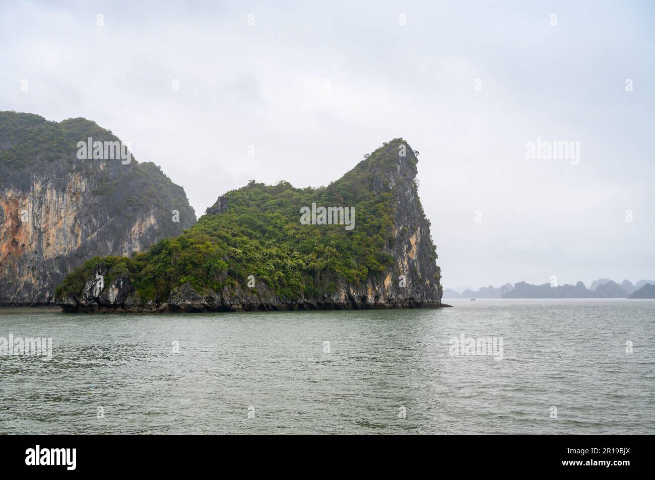 The typical limestone islands and islets in low clouds and mist in Bai ...