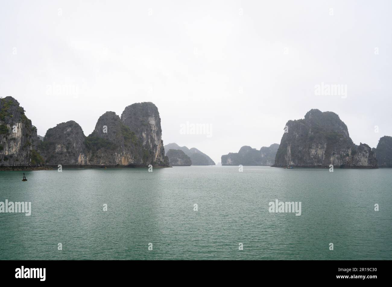 The typical limestone islands and islets in low clouds and mist in Bai ...