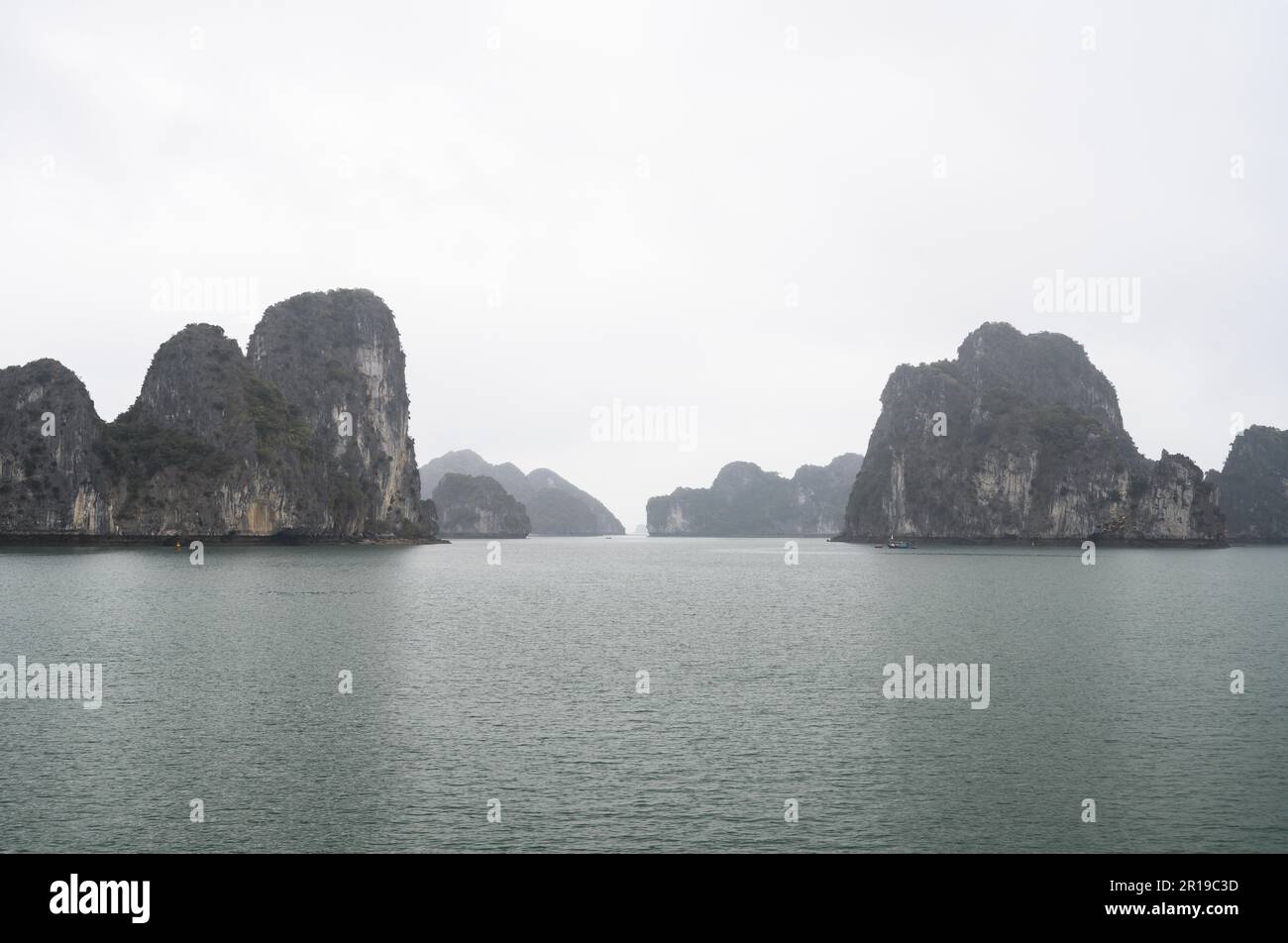 The typical limestone islands and islets in low clouds and mist in Bai ...