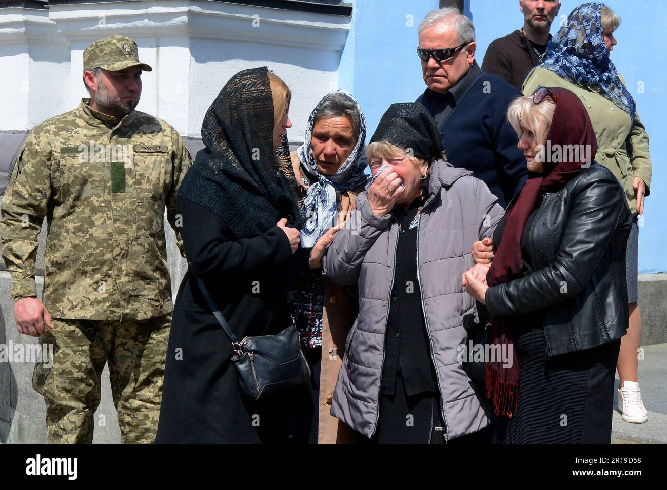 Kyiv, Ukraine. 12th May, 2023. Relatives cry near the coffin with the ...
