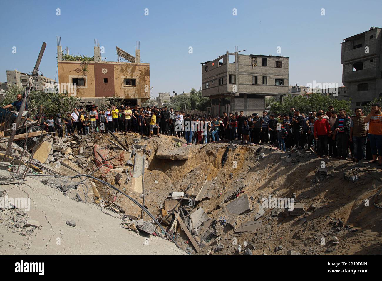 Gaza, Palestine. 12th May, 2023. Palestinians gather near destroyed ...