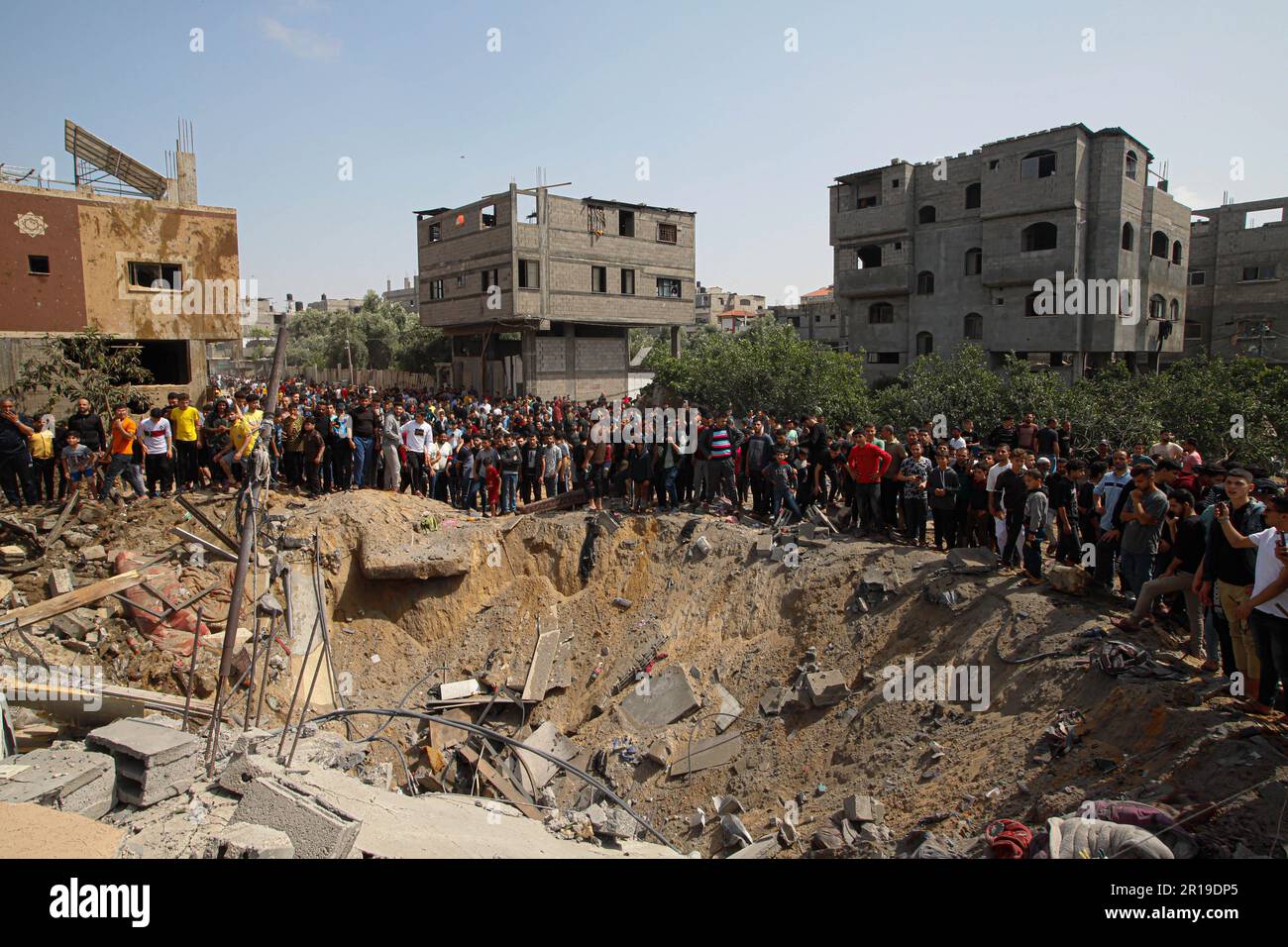 Gaza, Palestine. 12th May, 2023. Palestinians gather near destroyed ...