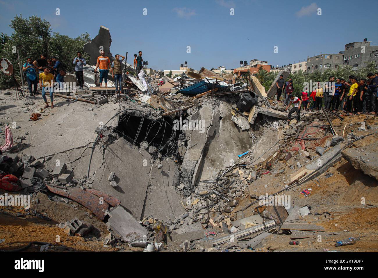 Gaza, Palestine. 12th May, 2023. Palestinians gather near destroyed ...