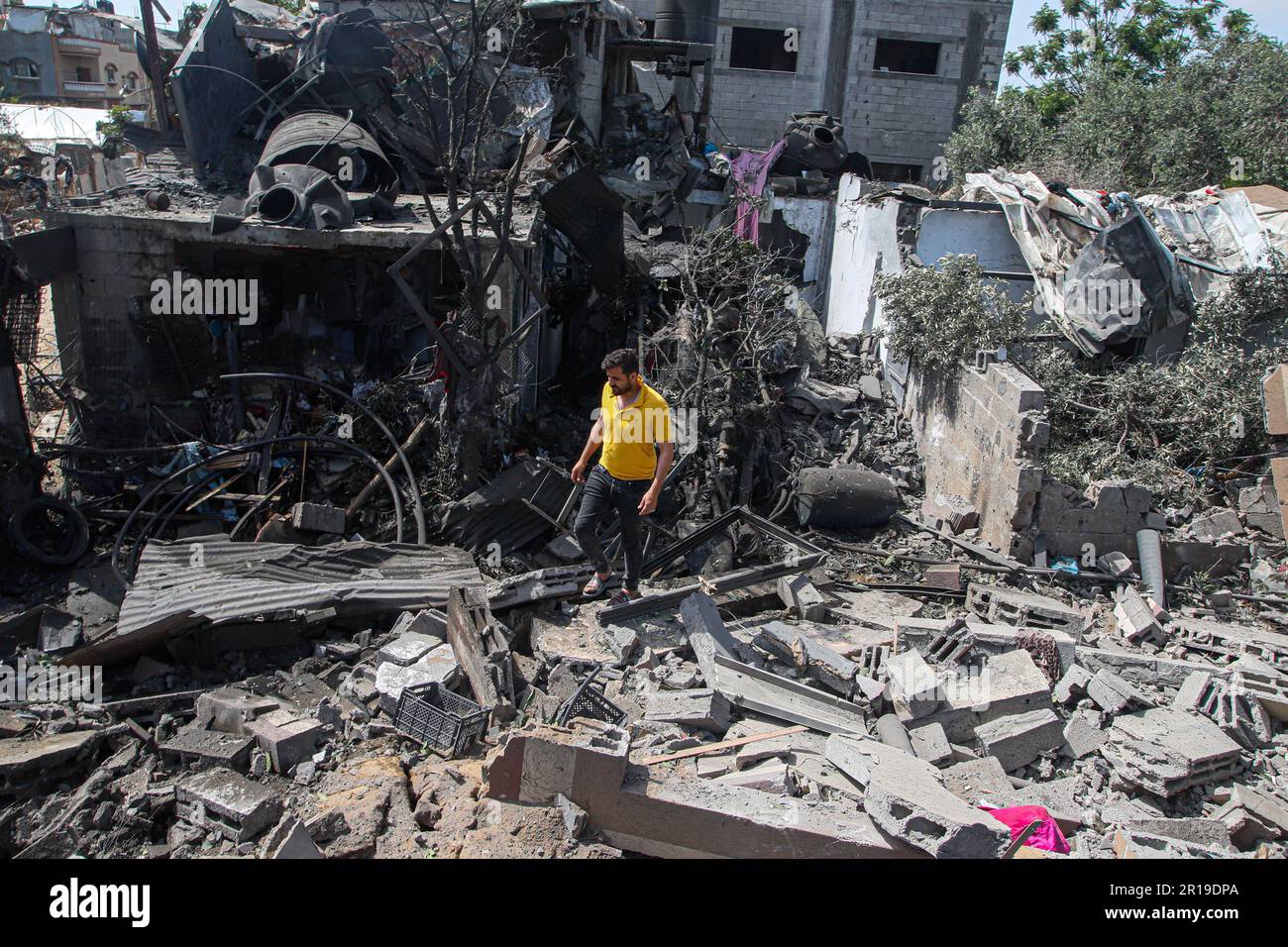Gaza, Palestine. 12th May, 2023. Palestinians gather near destroyed ...