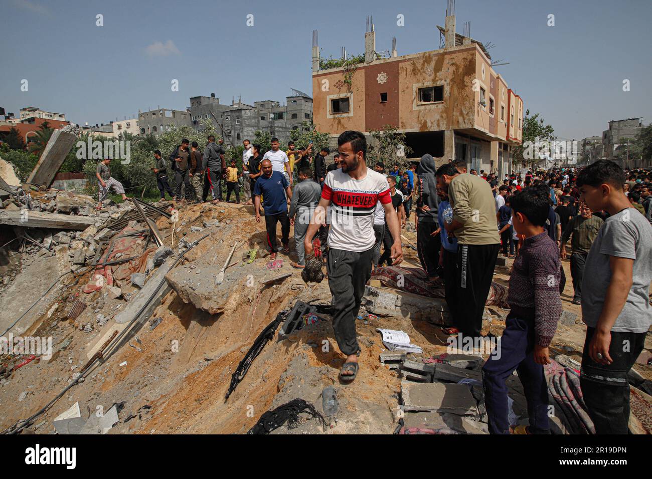 Gaza, Palestine. 12th May, 2023. Palestinians gather near destroyed ...