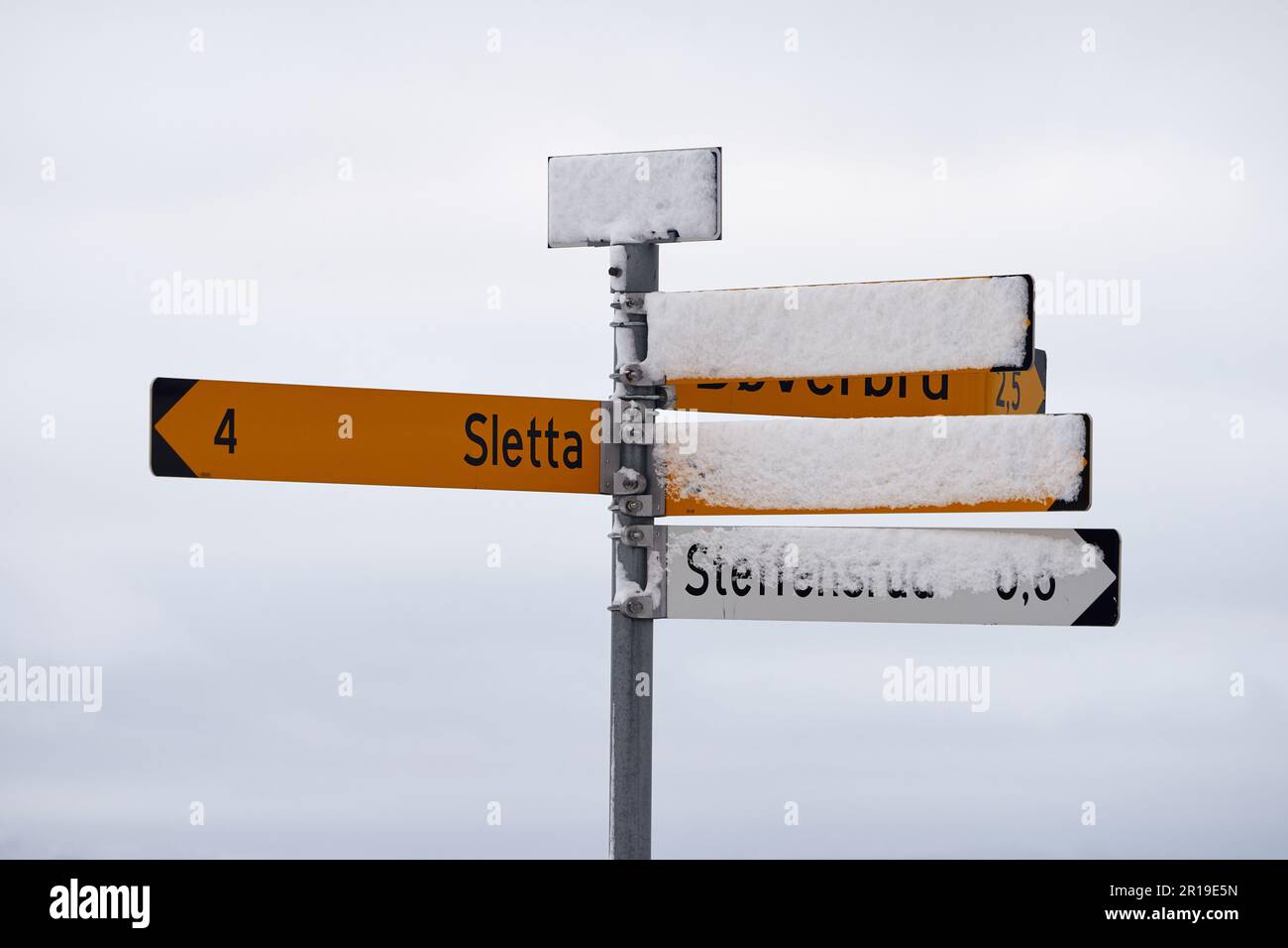 A signpost stands in the small town of Toten, Norway, with a variety of ...