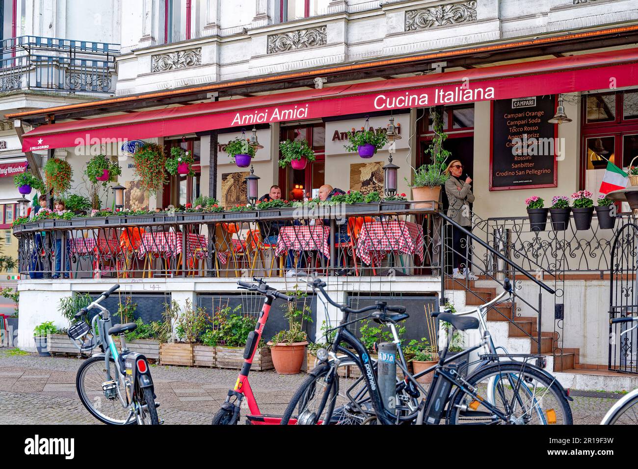 Berlin, Germany - May 7, 2023: Street scene with an italian restaurant ...
