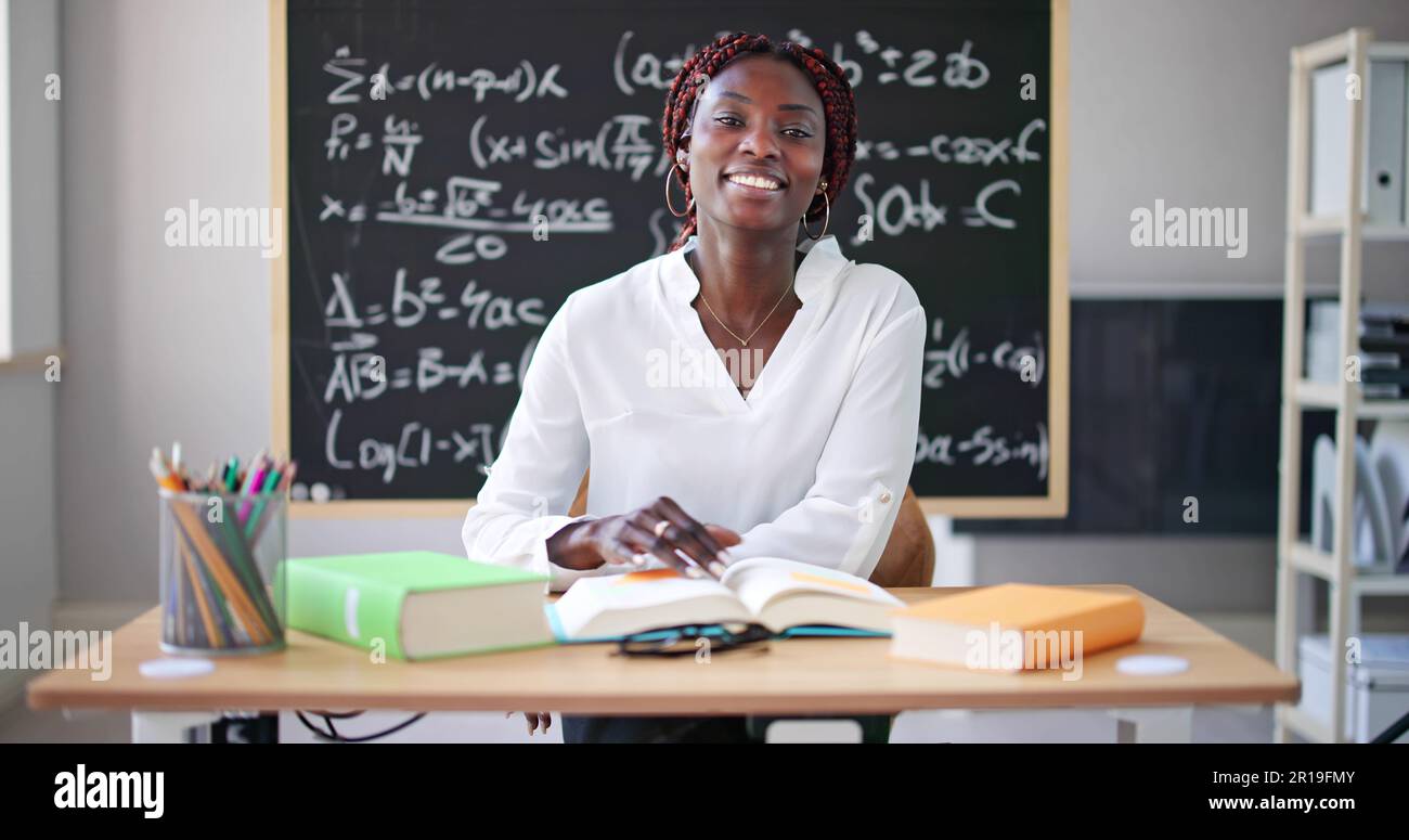African teacher holding books hi-res stock photography and images - Alamy