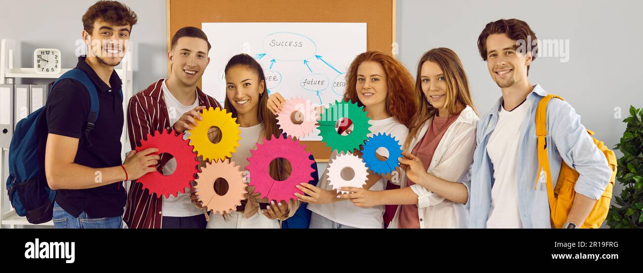 Team of happy students connecting gears illustrating concept of ...
