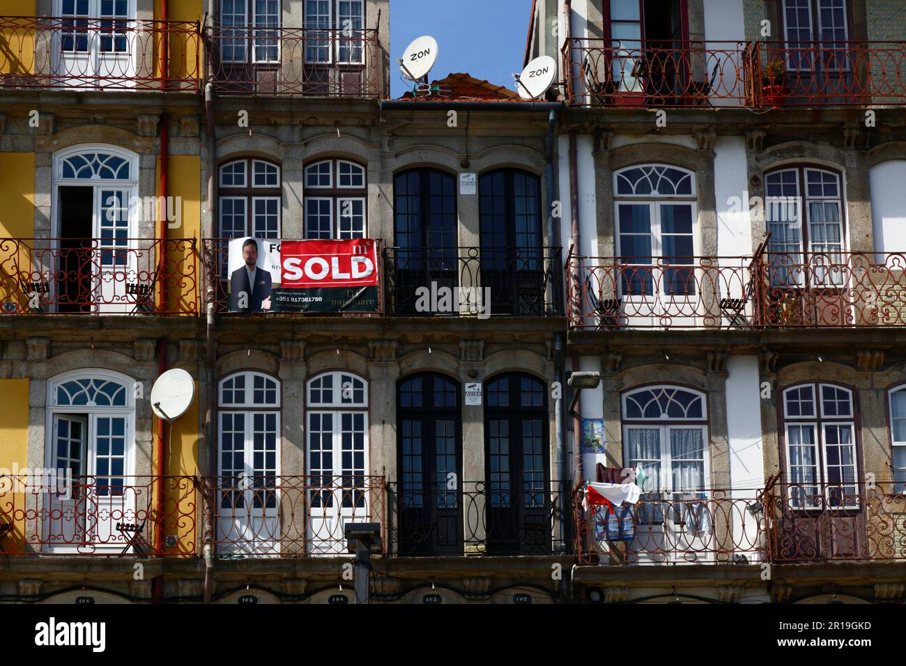 Sold sign on balcony of historic apartment building on the waterfront ...
