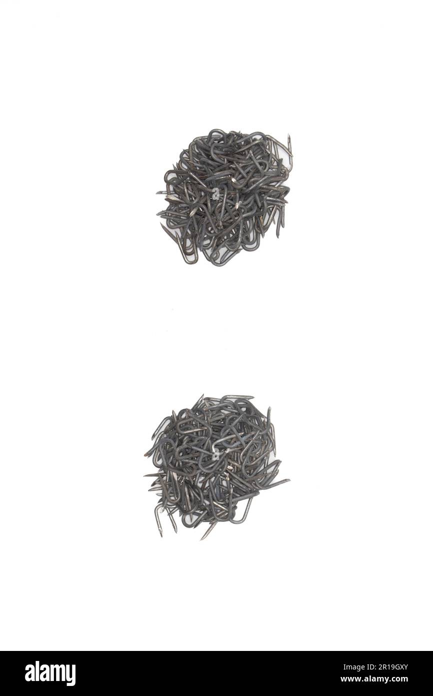 artistic isolated punctuation colon made from steel staples isolated on ...