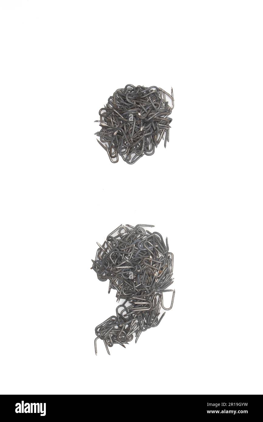 artistic isolated punctuation semi-colon made from steel staples ...