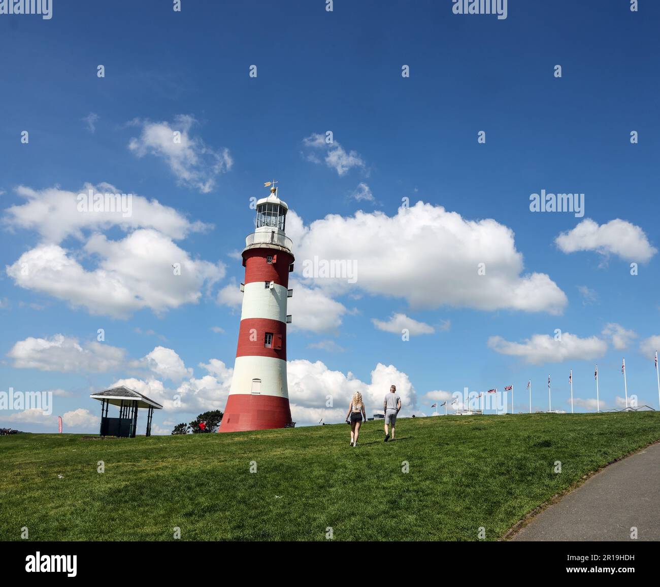 Smeatons Tower on Plymouth Hoe. Union Jacks fill the flag poles shortly ...
