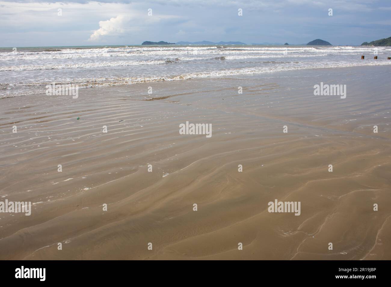 View of scenic sandy beach at Pantai Beringgis during overcast day ...