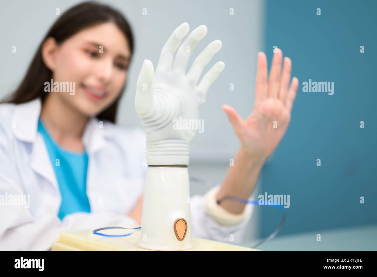 Technician testing robotic bionic arm at prosthetic manufacturing Stock ...