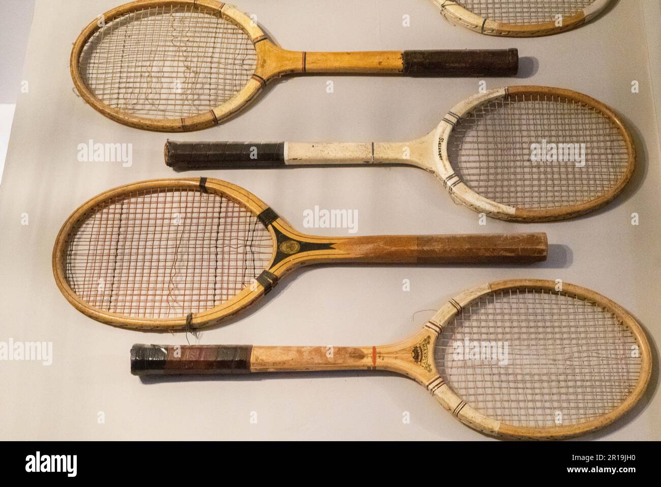 Old wooden tennis raquets hanging on a wall, London, UK Stock Photo - Alamy