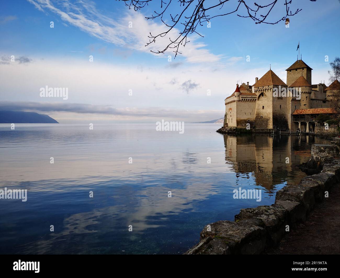 The ancient Chillon Castle on Lake Geneva against a blue sky Stock ...