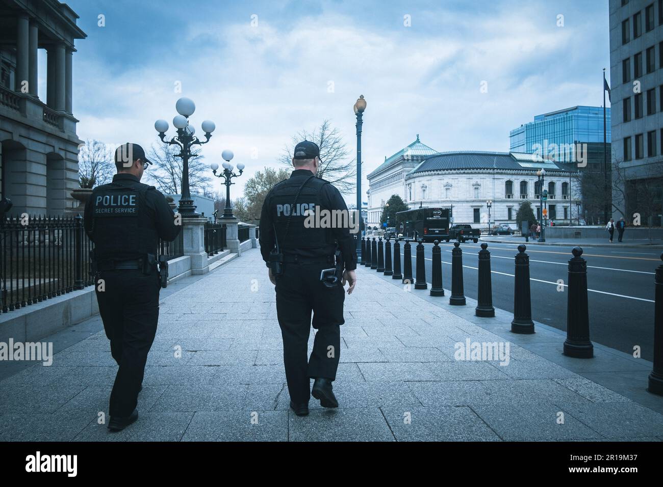 The two police officers walking side-by-side on a city sidewalk Stock ...