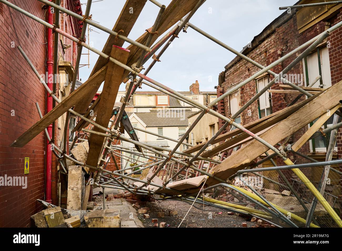 Building scaffold collapsed in alleyway Stock Photo - Alamy