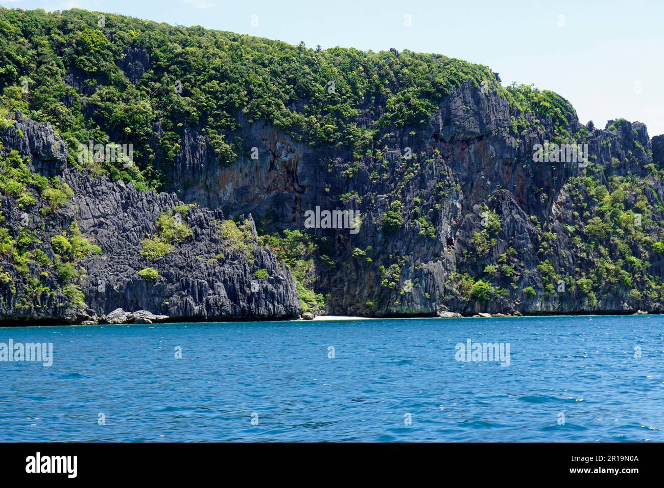 massive limestone rocks in the blue sea at the el nido archipelago ...