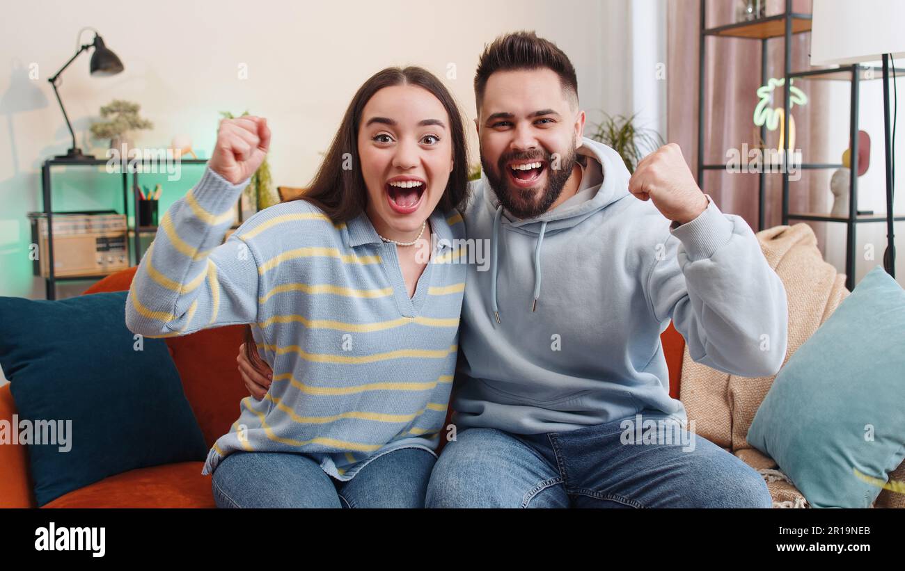 Young family married couple man woman shouting, celebrating success ...