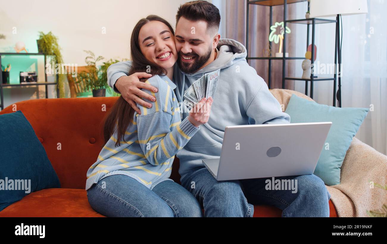 Planning budget. Rich happy young family married couple man woman ...