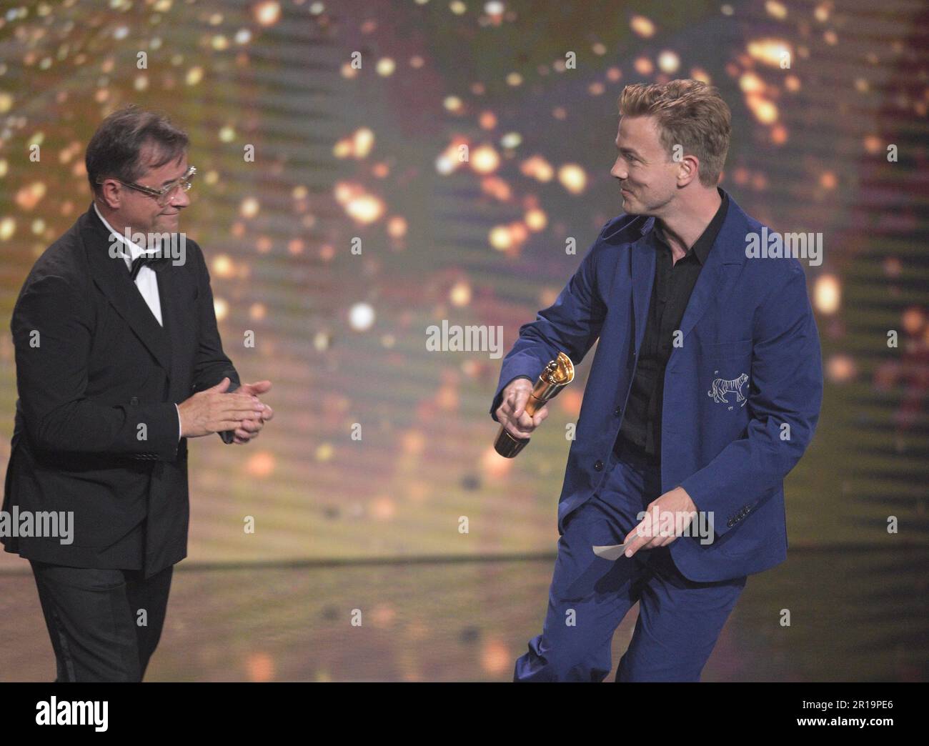 Berlin, Germany. 12th May, 2023. Actor Albrecht Schuch (r) receives the ...