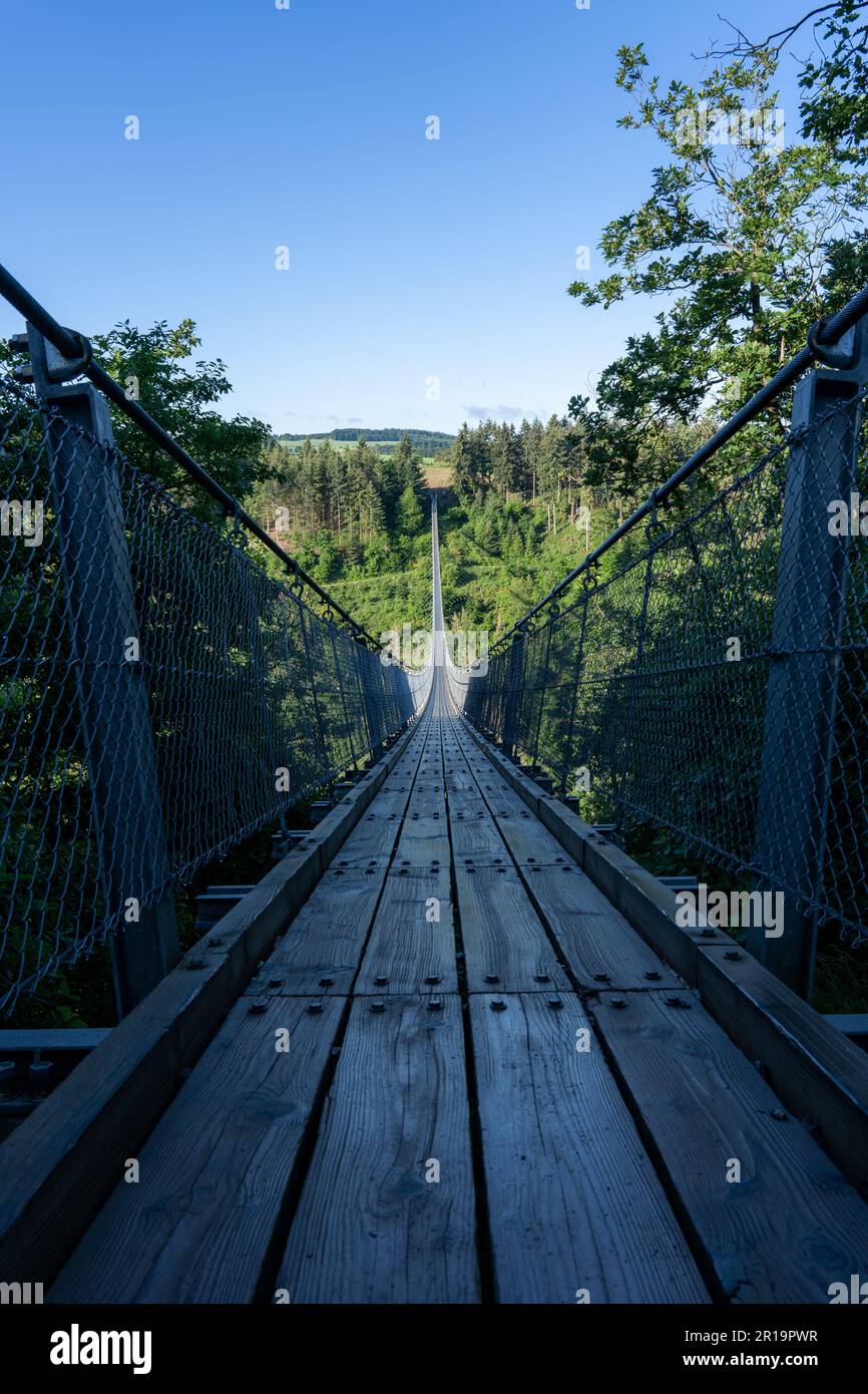 The Geierlay Suspension Bridge against the background of blue sky and ...