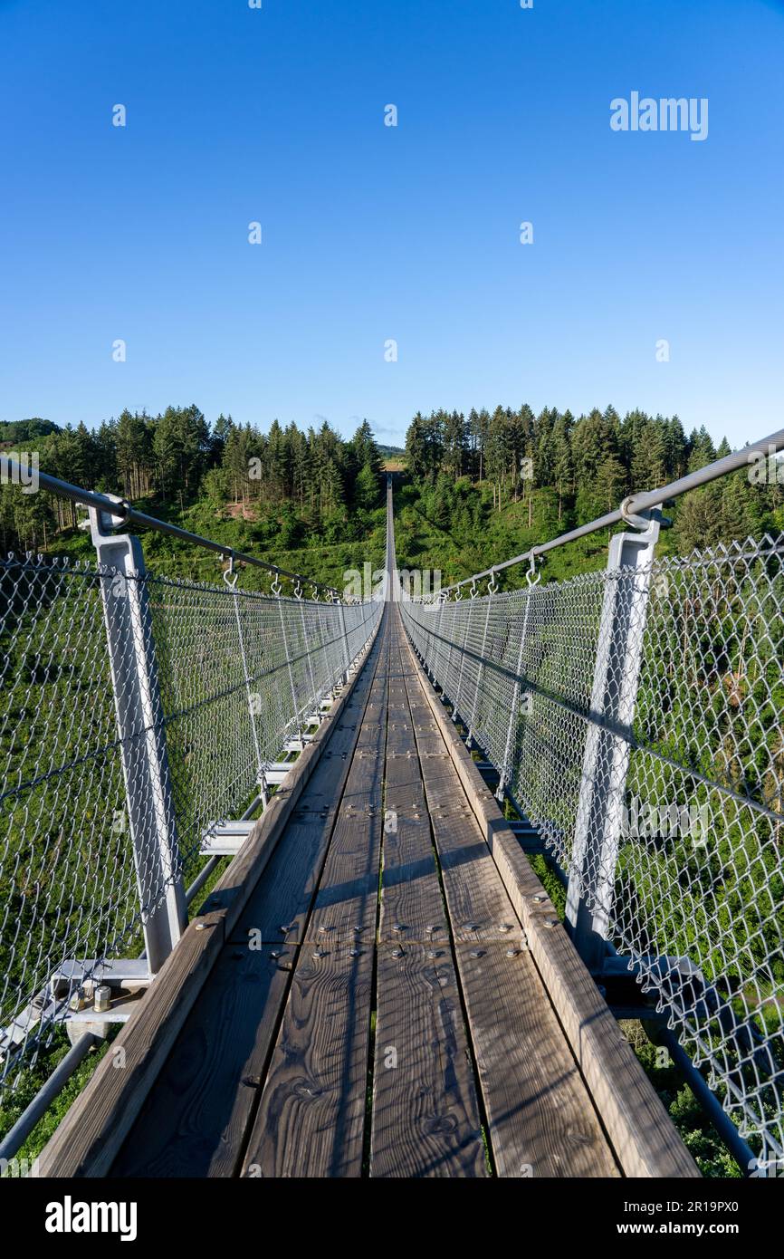 The Geierlay Suspension Bridge against the background of blue sky and ...